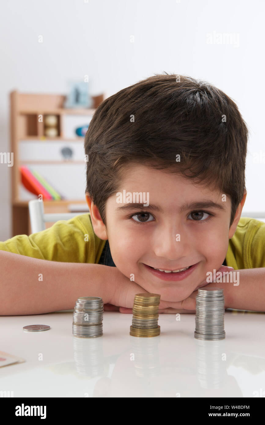Portrait of a boy with his savings and smiling Stock Photo - Alamy
