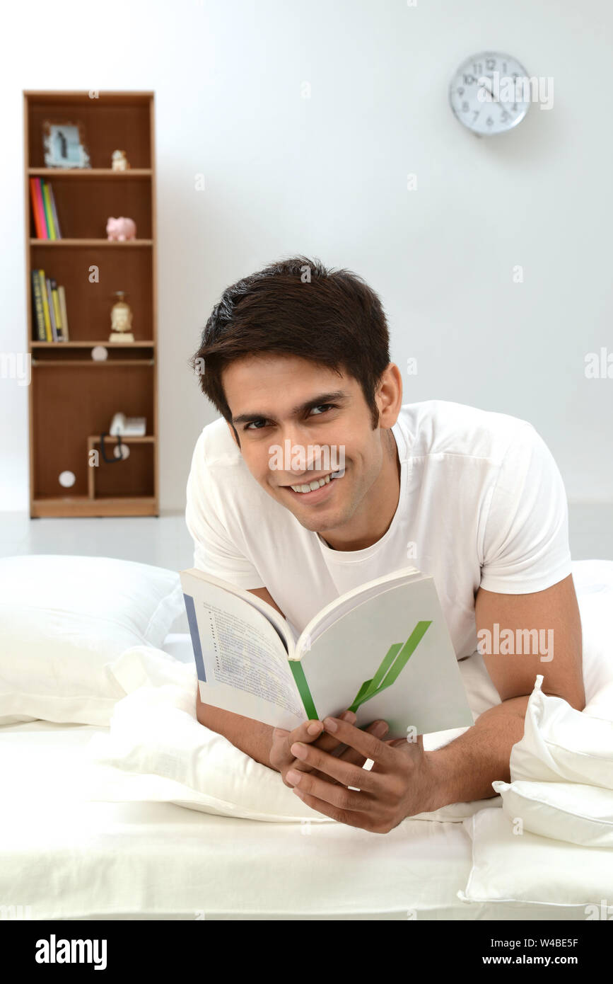 Man reading a book and smiling Stock Photo - Alamy