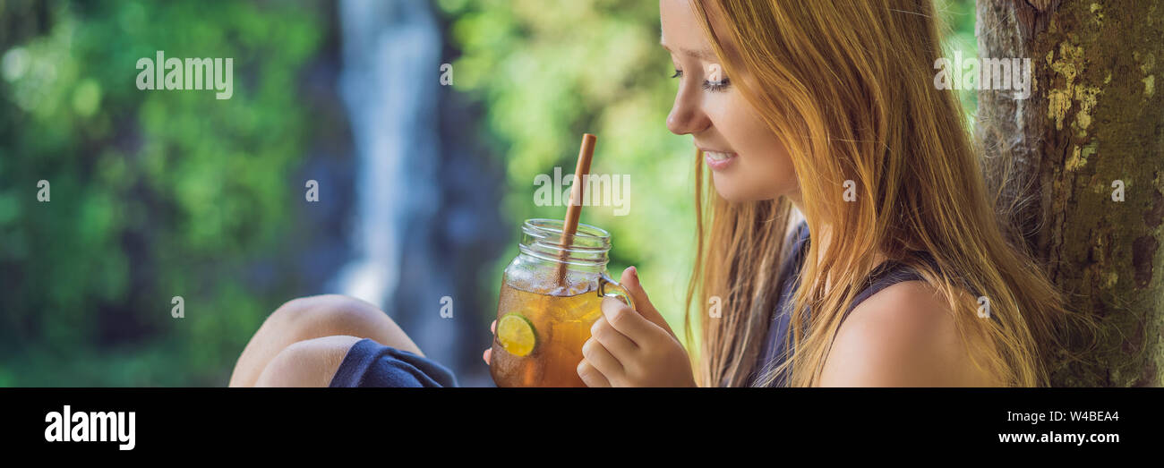 Closeup portrait image of a beautiful woman drinking ice tea with ...