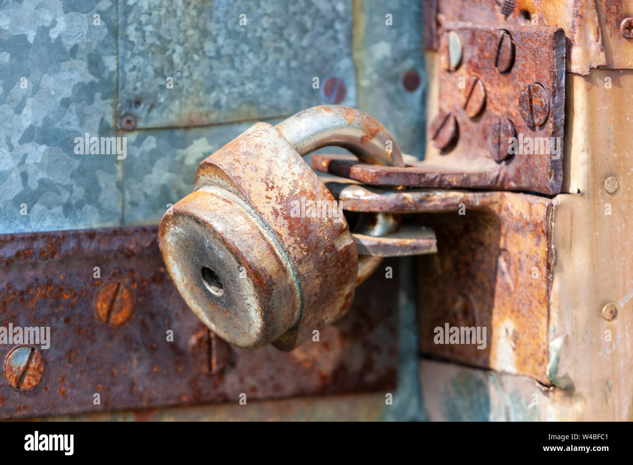 Padlock on the door. Rusty gate Close up Stock Photo - Alamy