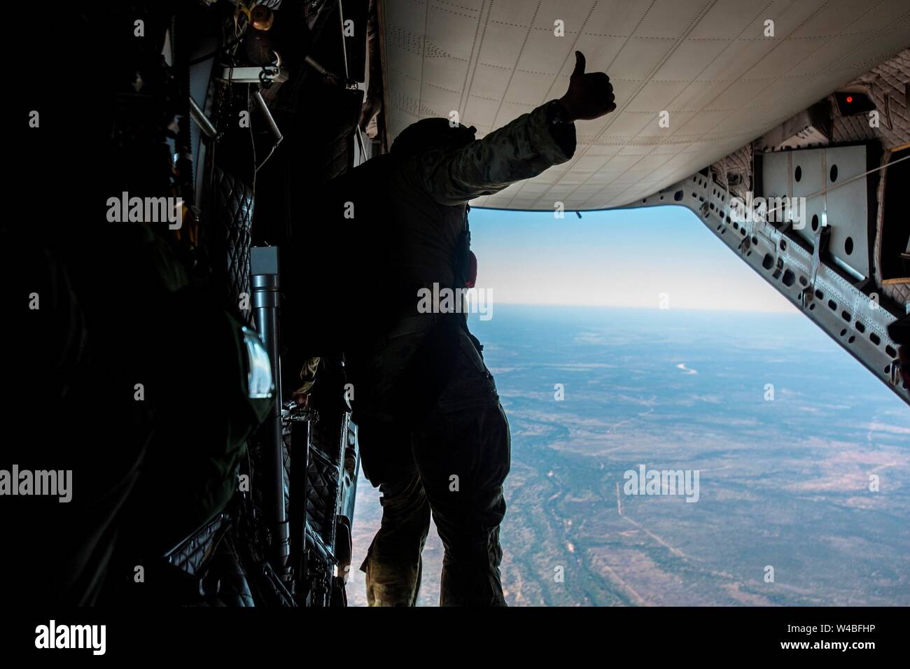 A Royal Australian Air Force (RAAF) loadmaster signals U.S. and Australian special operations ...