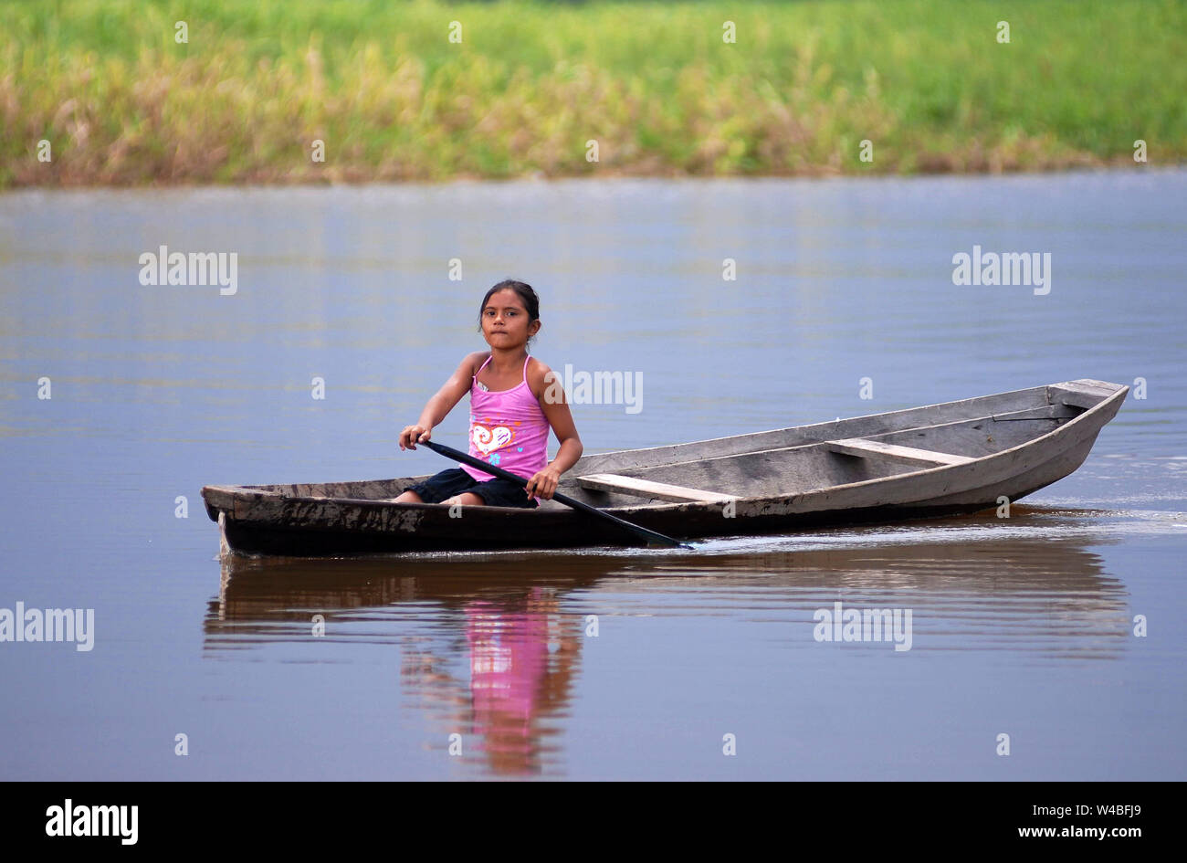 River child using canoe to go to school.Main means of transportation of ...