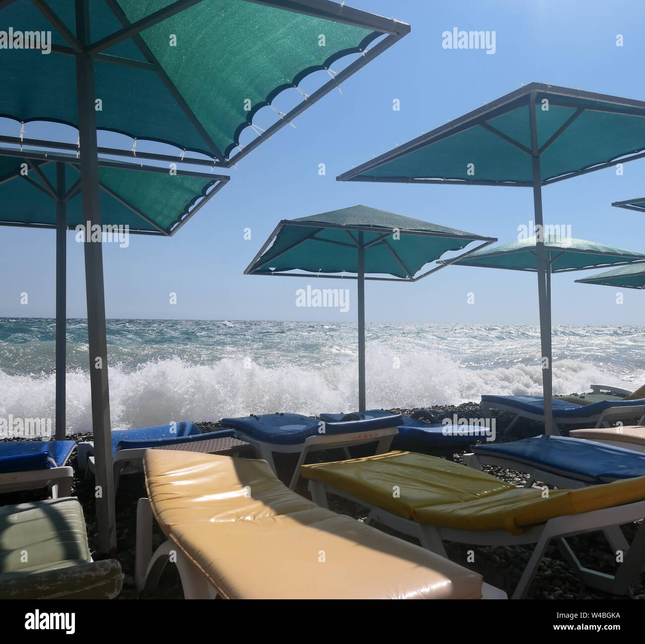 Windy beach with white umbrellas hi-res stock photography and images ...