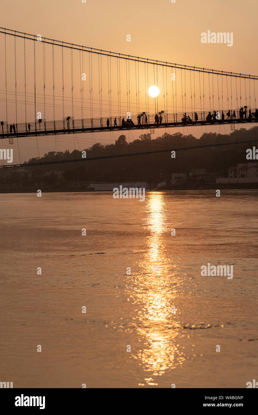 Beautiful view of Ganges river water and Ram Jhula bridge at sunset ...