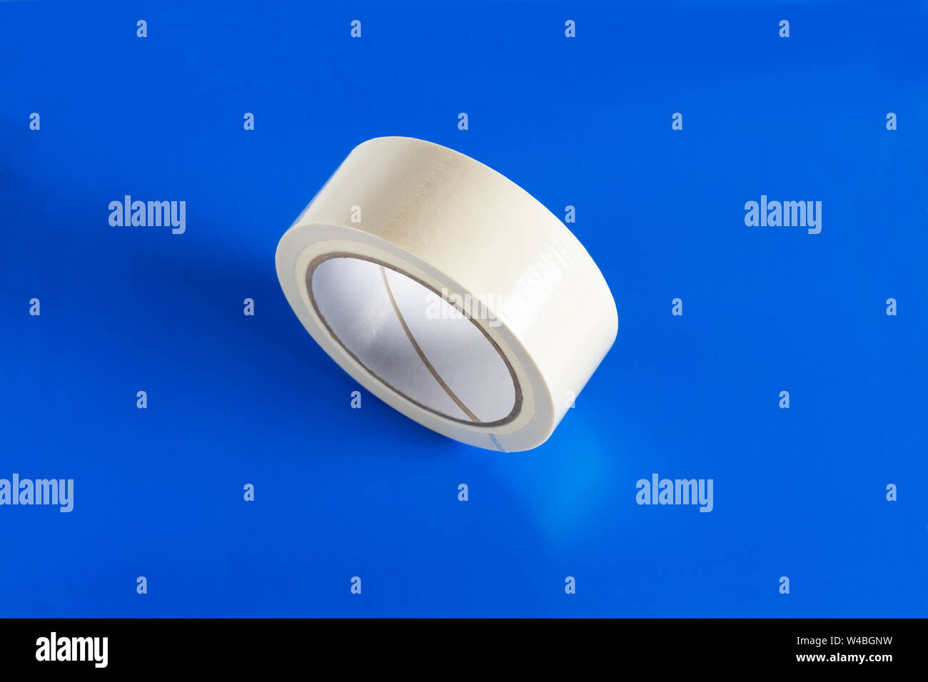 Masking tape paper. Close-up on a blue background Stock Photo - Alamy