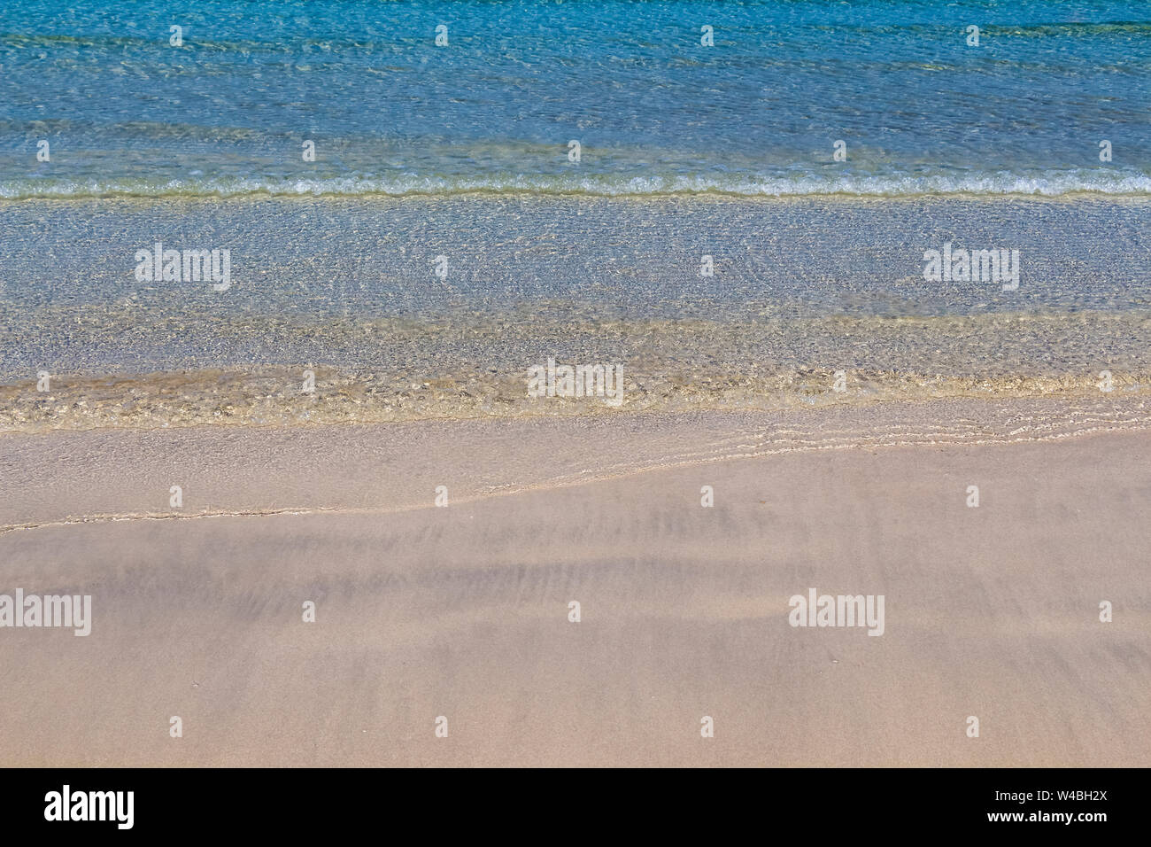 Clear sea water washes the sandy shore of the beach Stock Photo - Alamy