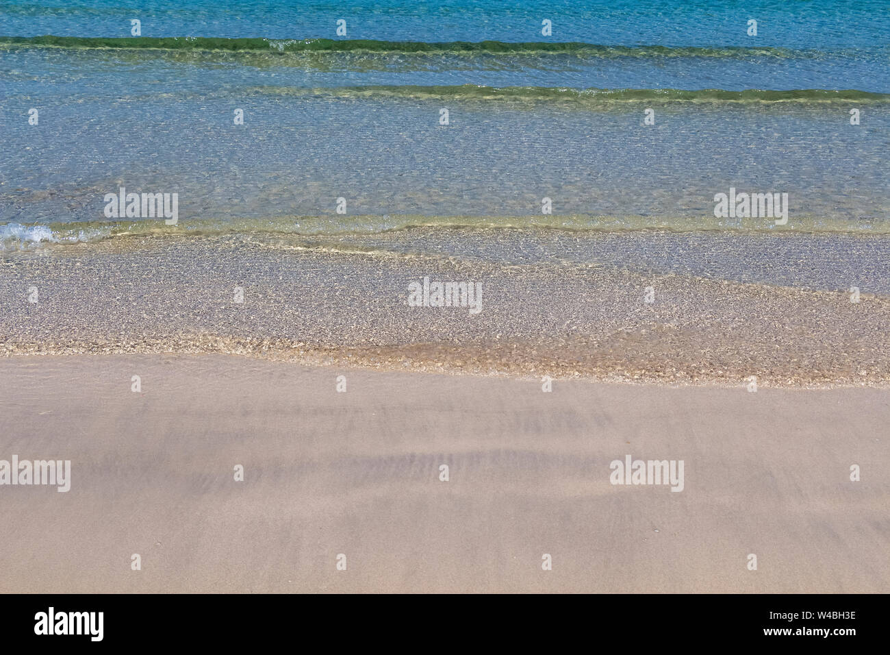 Clear sea water washes the sandy shore of the beach Stock Photo - Alamy