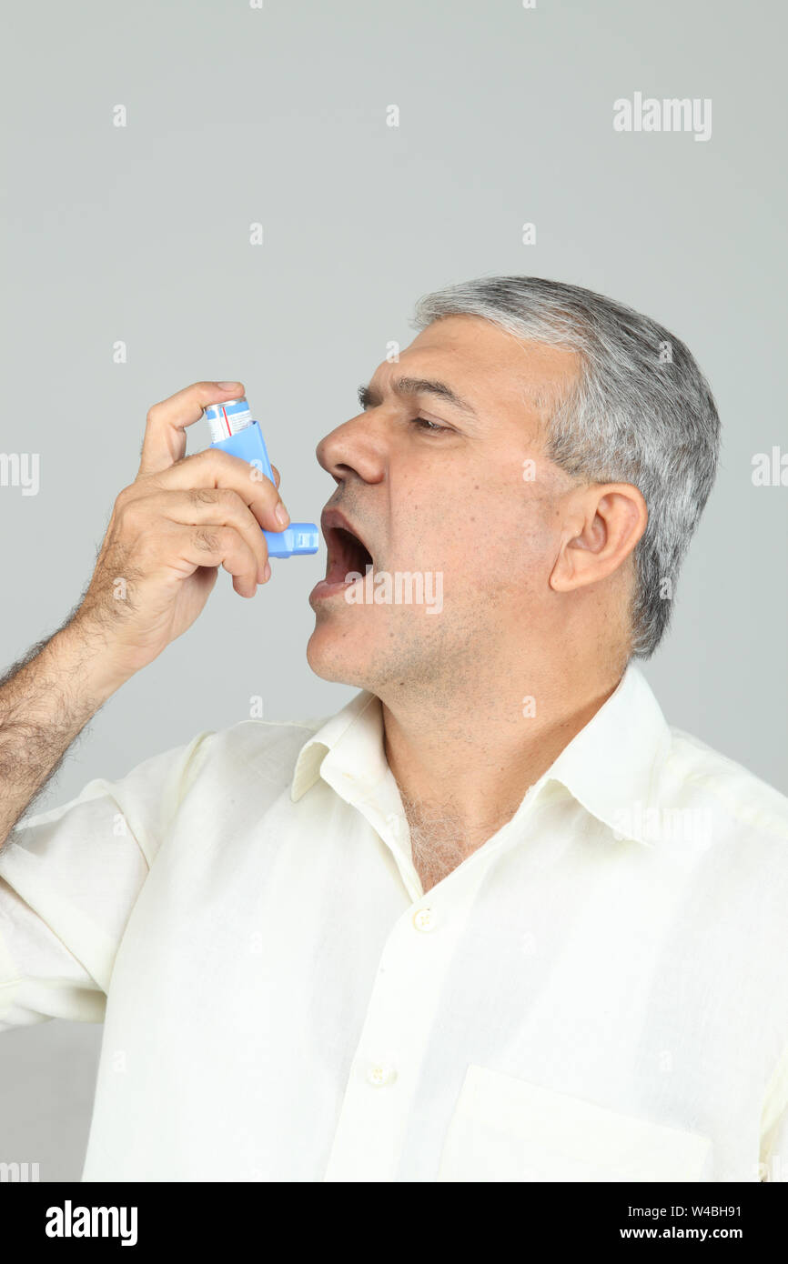 Old man using asthma inhaler Stock Photo - Alamy