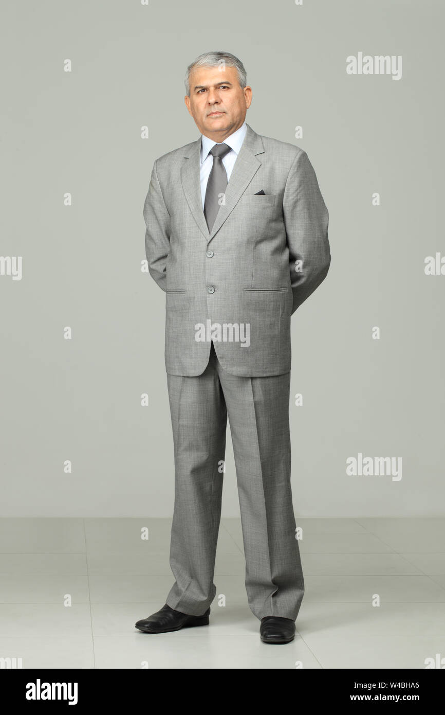 Businessman standing with hands behind back Stock Photo - Alamy Businessman standing with hands behind back Stock Photo - Alamy