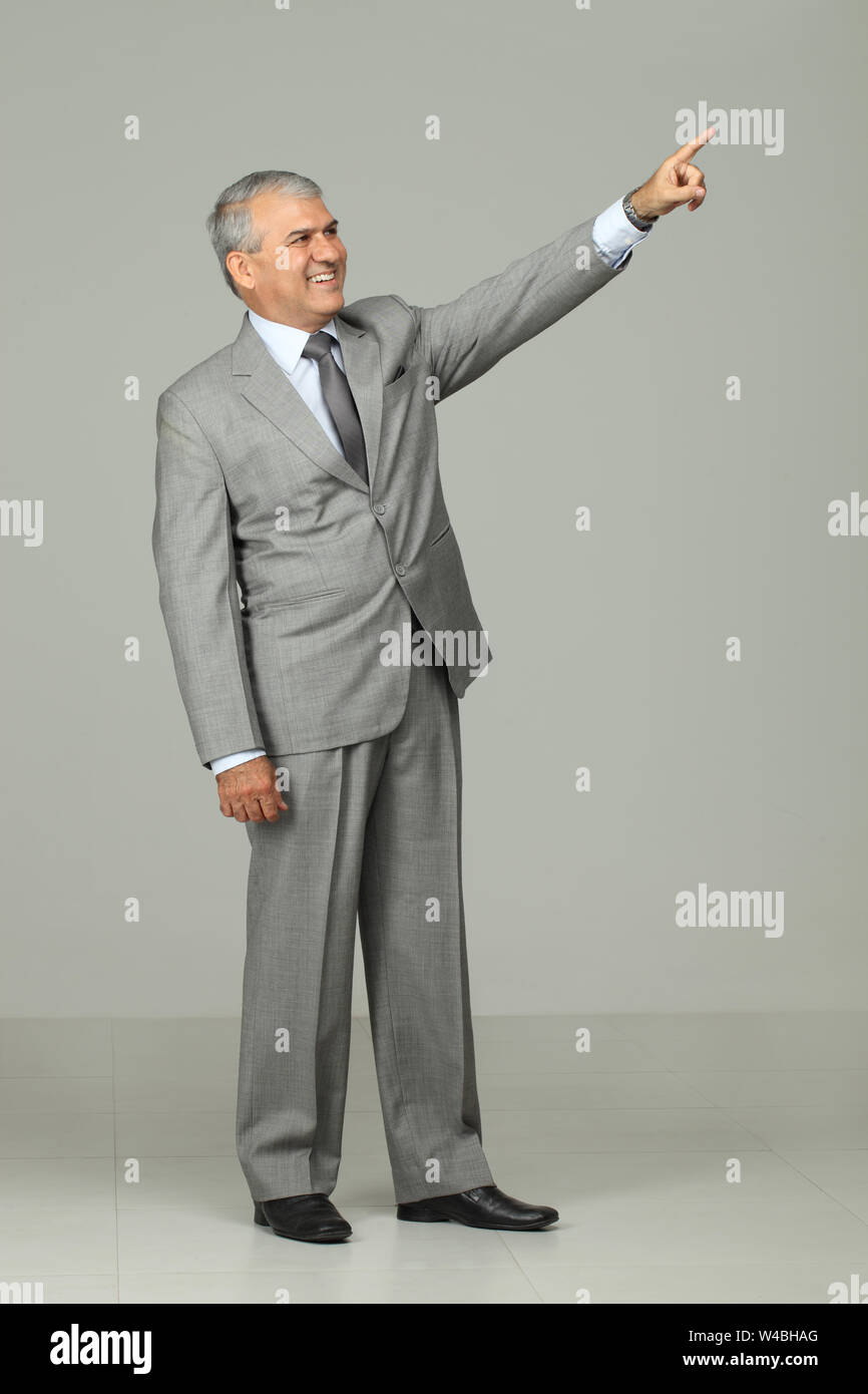 Businessman pointing and smiling Stock Photo - Alamy