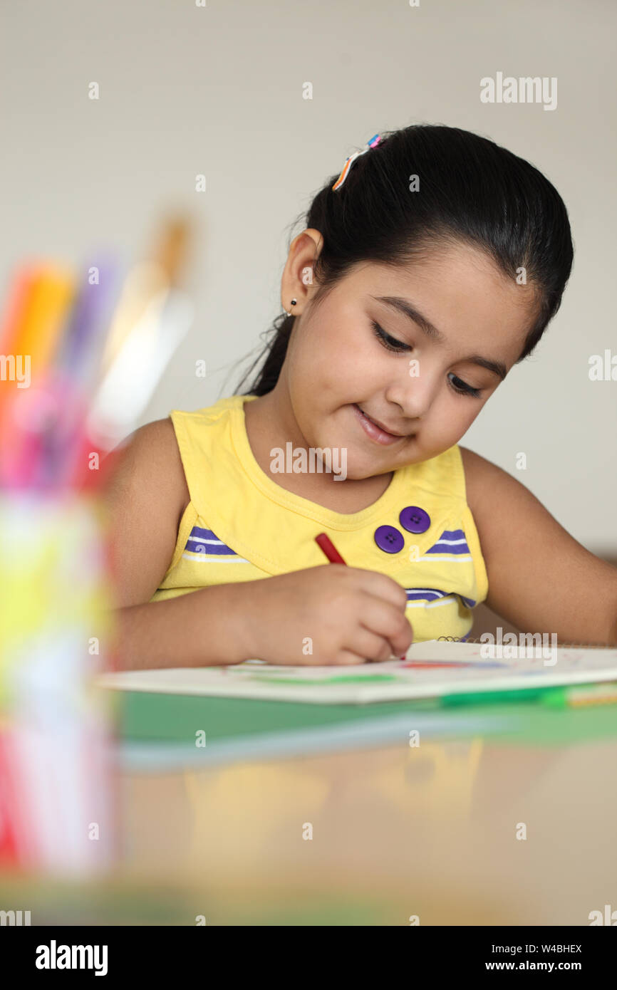 Girl coloring a book at home Stock Photo - Alamy