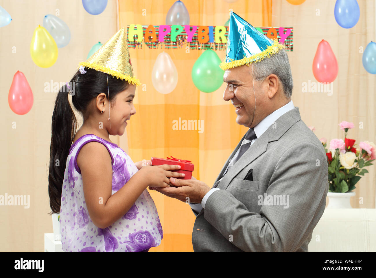 Girl giving gift to his grandfather on birthday Stock Photo - Alamy