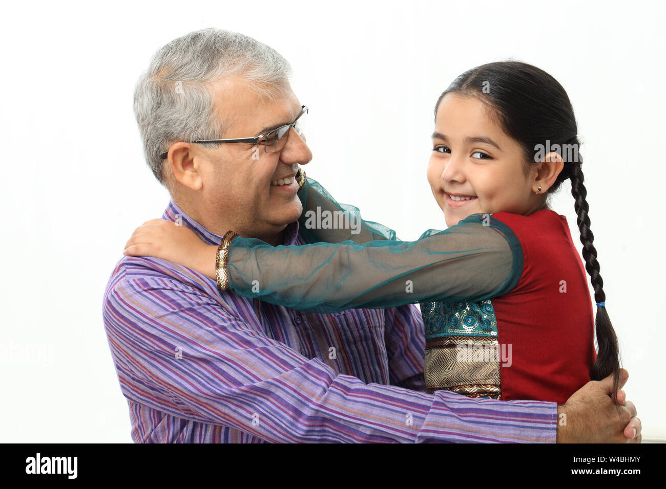 Old man hugging his granddaughter and smiling Stock Photo - Alamy