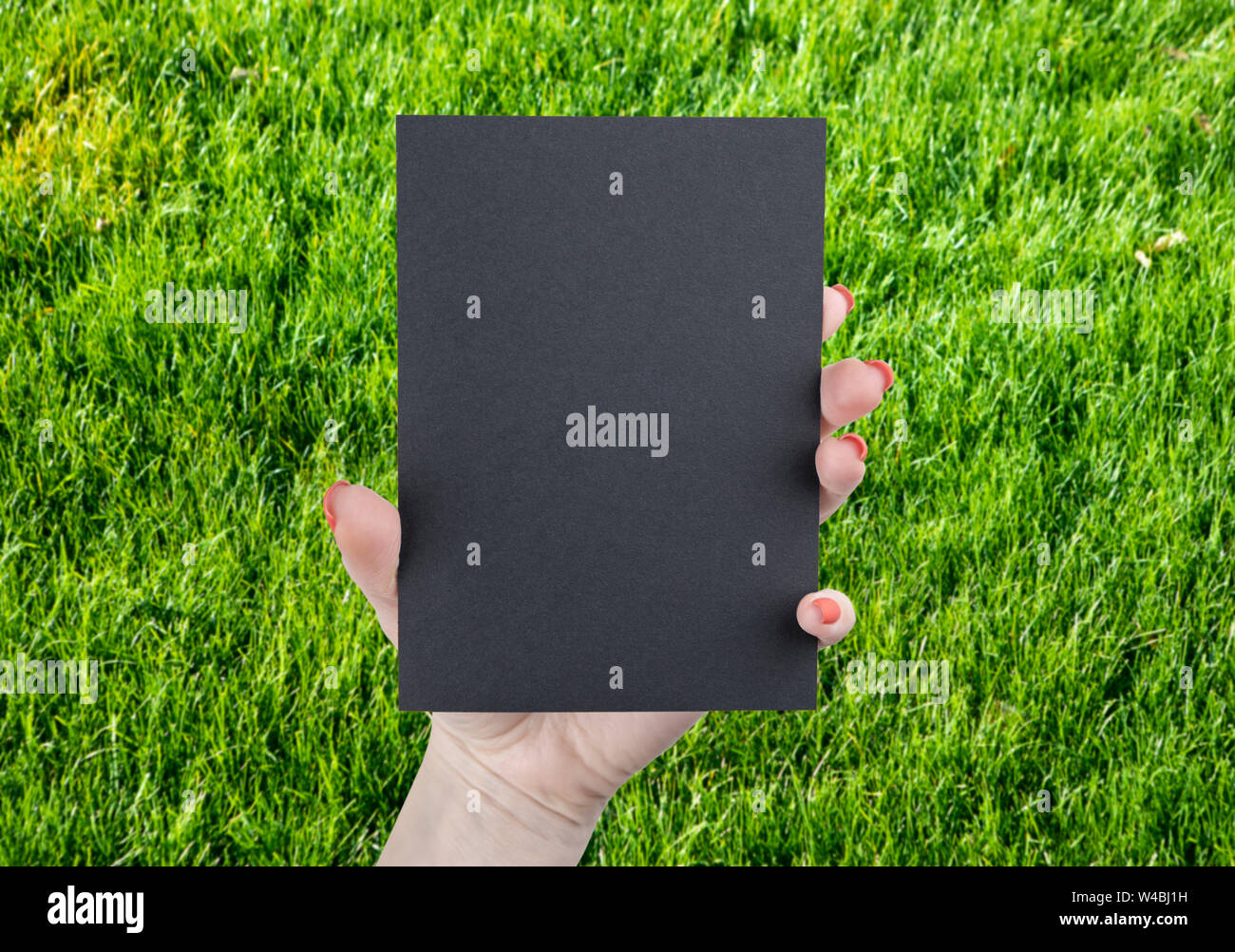 A woman holding black booklet. Identity template Stock Photo - Alamy