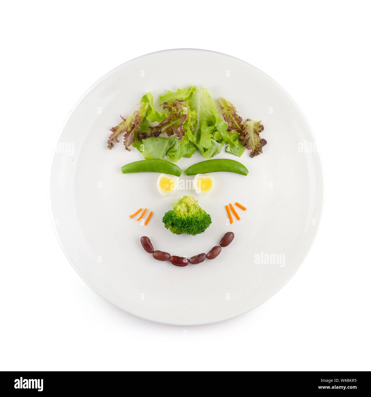 Fun food for kids - cute smiling clown face on salad decorated with ...