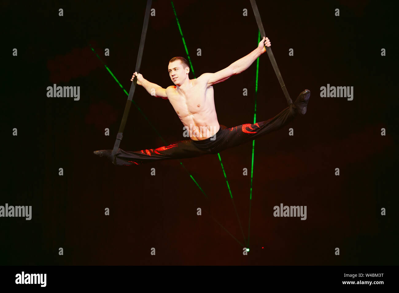 Acrobat performs a difficult trick in the circus Stock Photo - Alamy