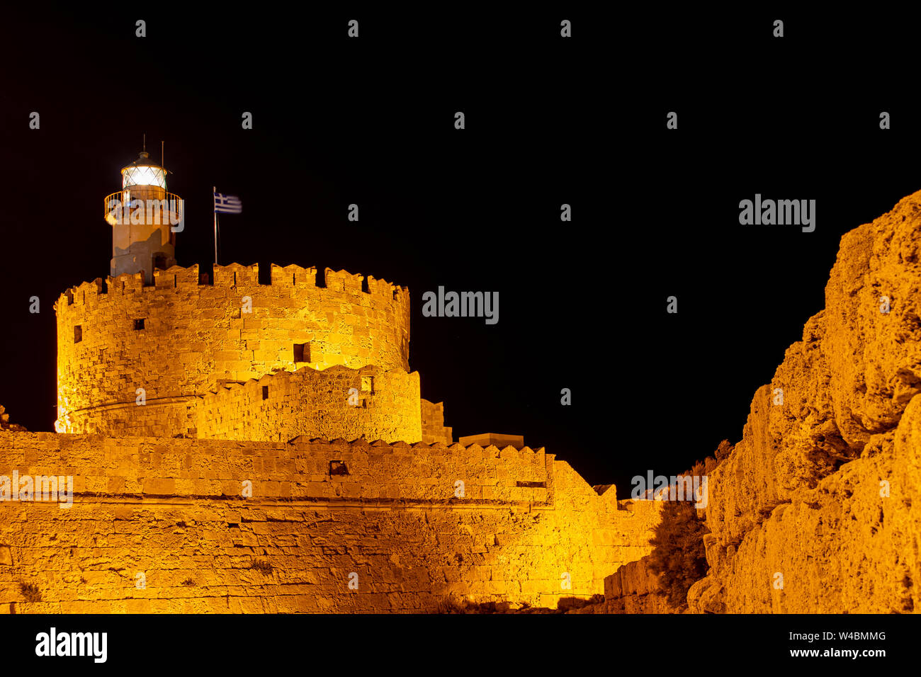 The historic Lighthouse (Fort St. Nicholas) in Rhodes, Greece at night ...