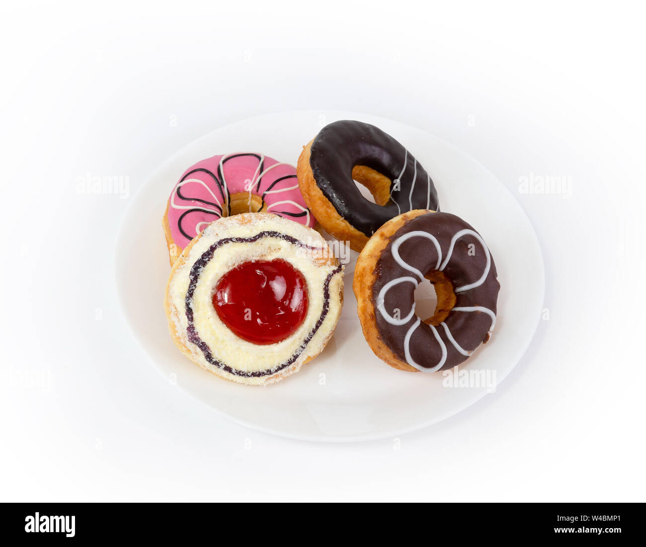 Four sweet donuts on plate on white background Stock Photo - Alamy