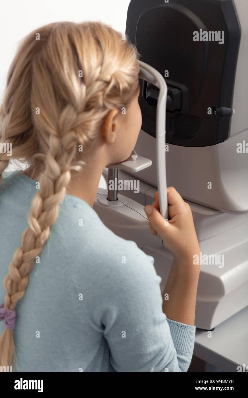 Girl visiting doctor. Blonde-haired teen girl wearing blue sweater ...