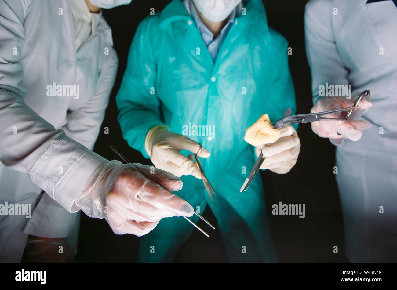 Hands close-up of surgeons holding medical instruments. The surgeon ...