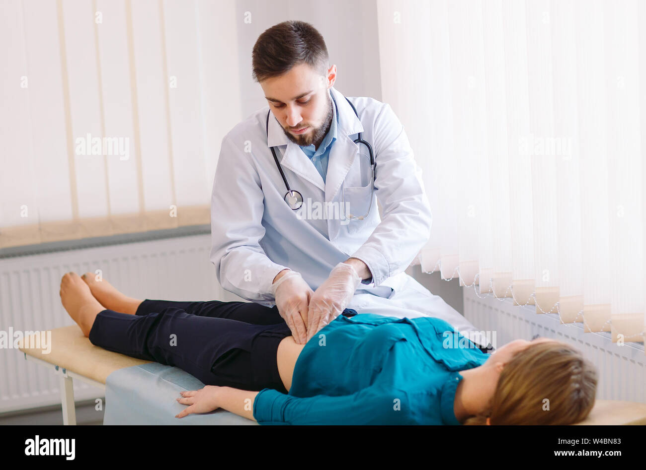 Female doctor examines male patient hi-res stock photography and images ...