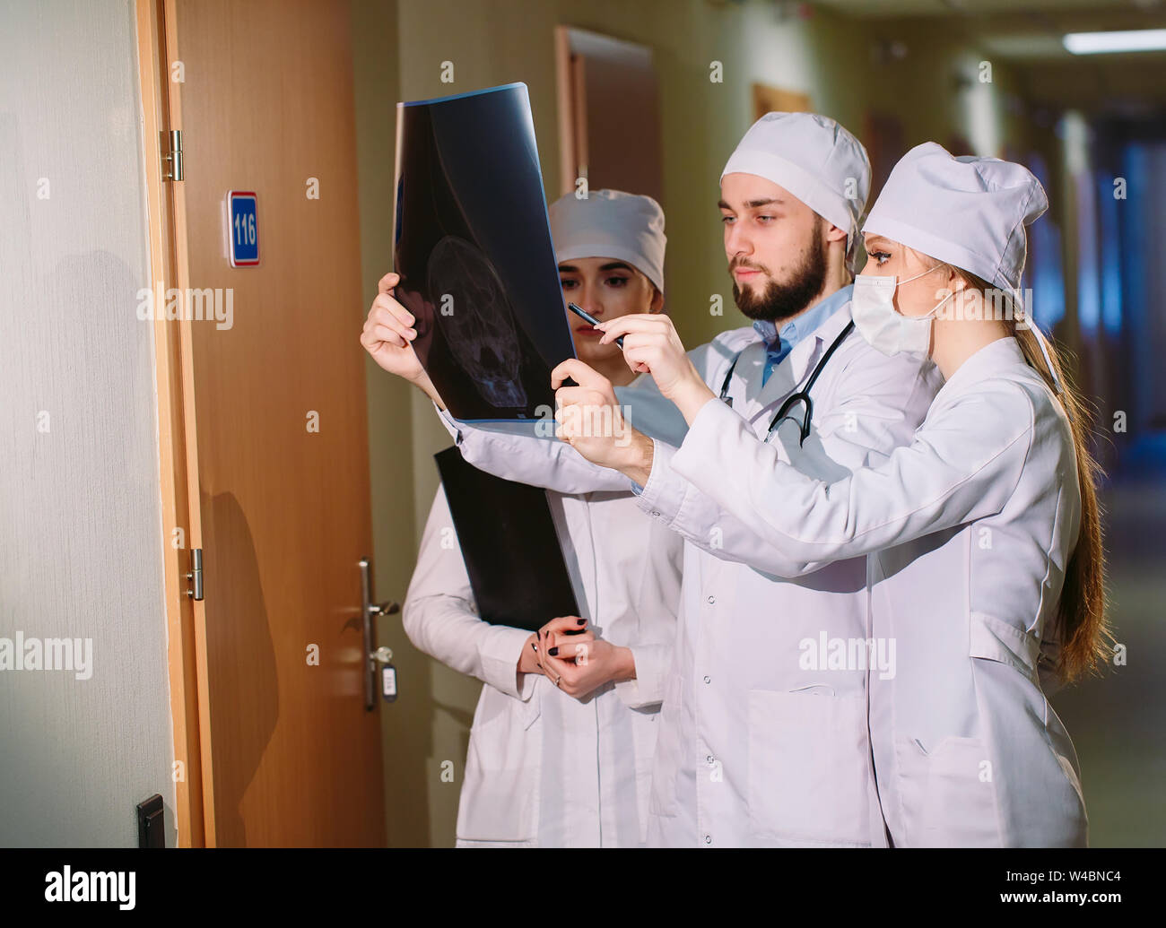 Doctors watching x-ray of patient near the hospital room Stock Photo ...
