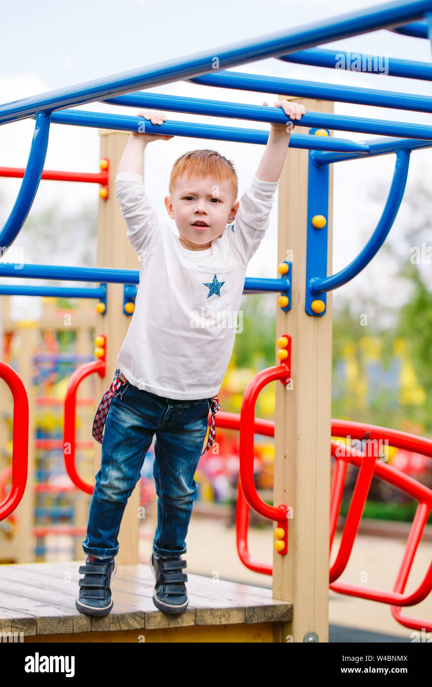 Little boy playing on the playground outdoors Stock Photo - Alamy