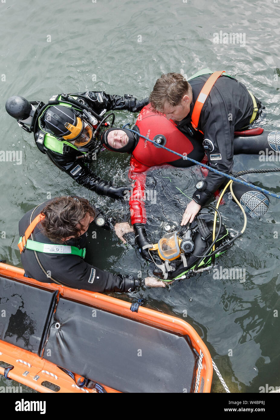 13 July 2019, Schleswig-Holstein, Wacken: Fire divers rescue a diver ...