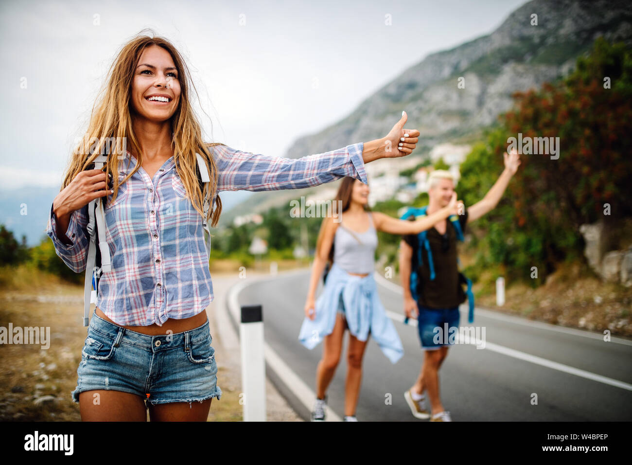 Group of backpackers and young friends traveling and having fun ...