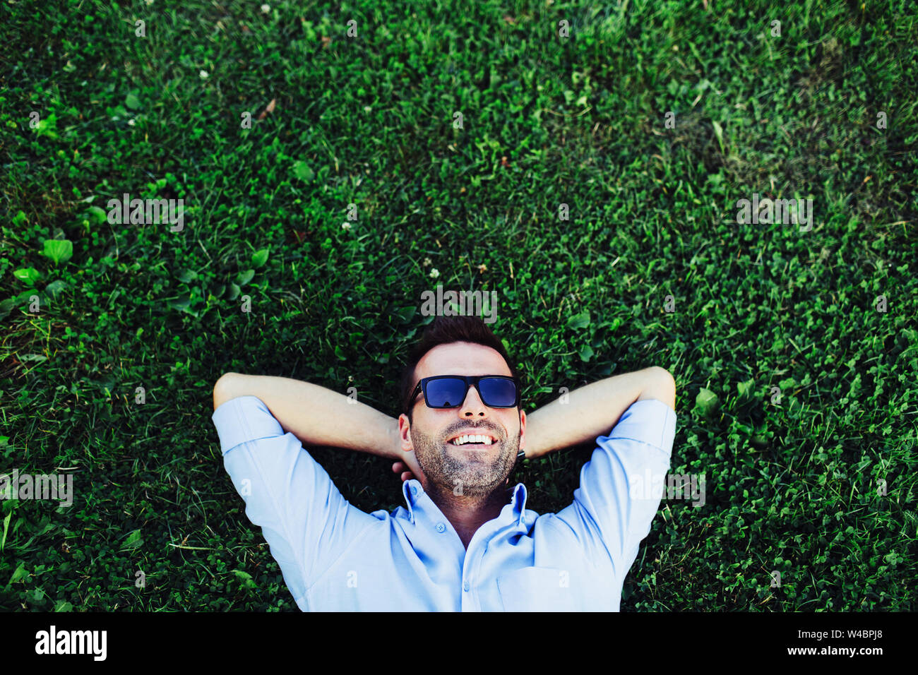 Handsome man hands under head hi-res stock photography and images - Alamy