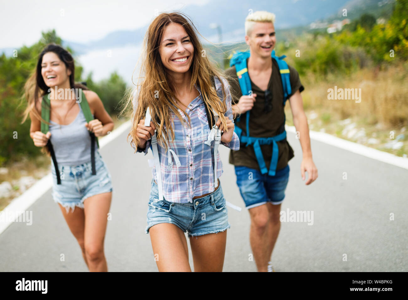Group of friends backpackers walking and traveling outdoor Stock Photo ...