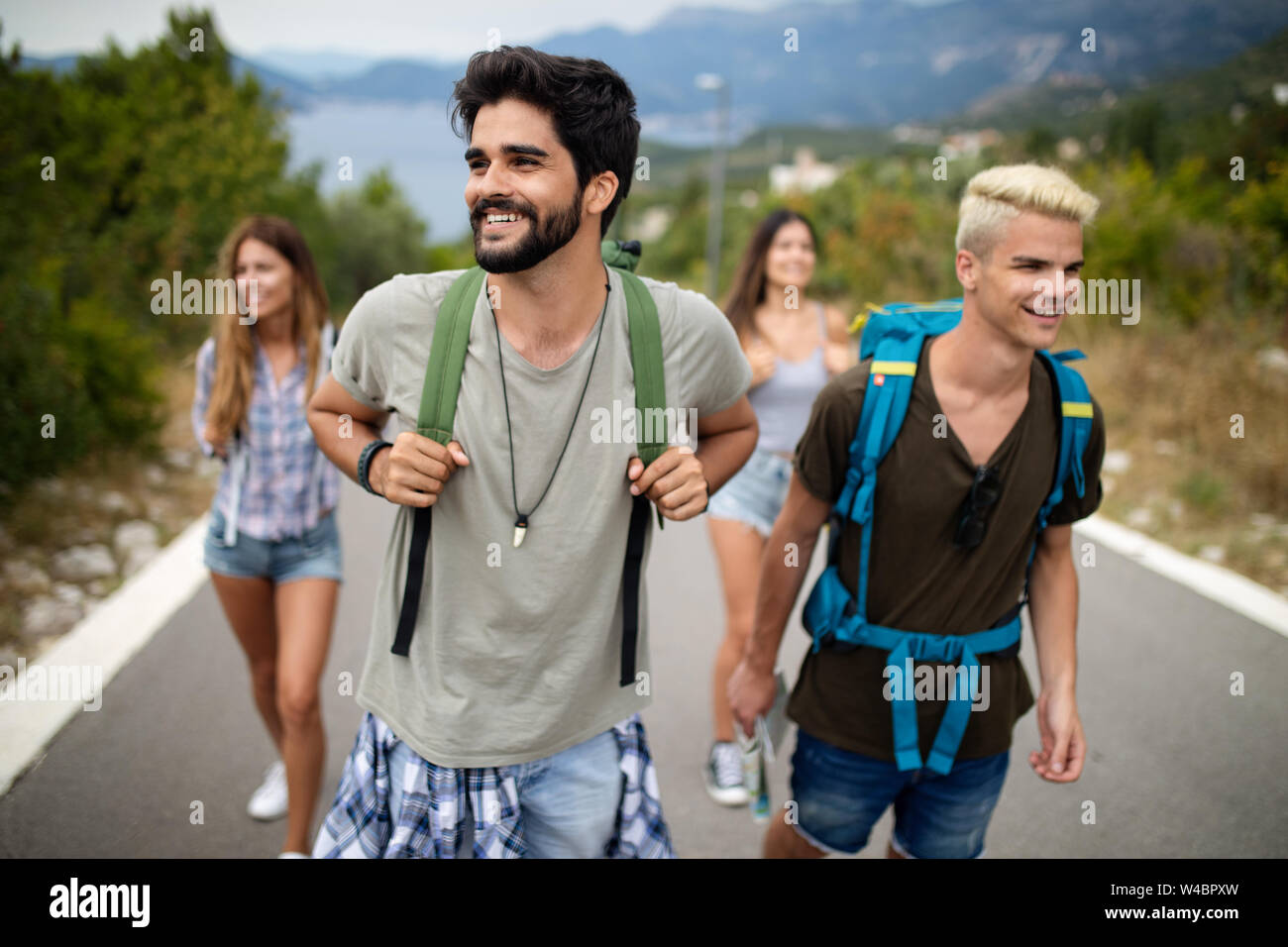 Group of friends backpackers walking and traveling outdoor Stock Photo ...