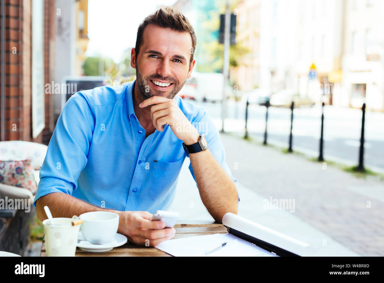 Young man sitting at outdoor cafe hi-res stock photography and images ...