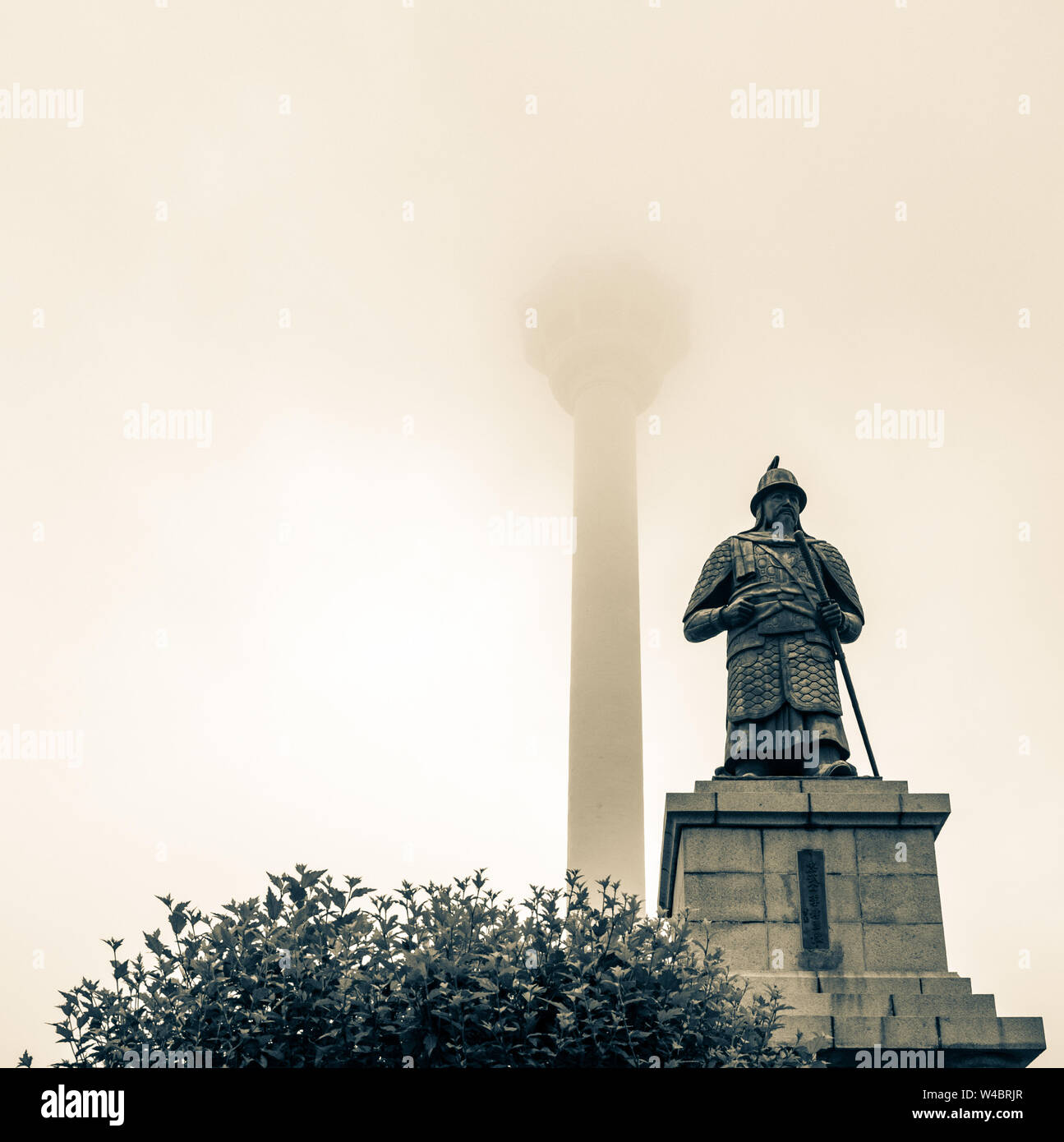 Busan Tower and Statue of Admiral Yi Sun-sin in front on a foggy day ...