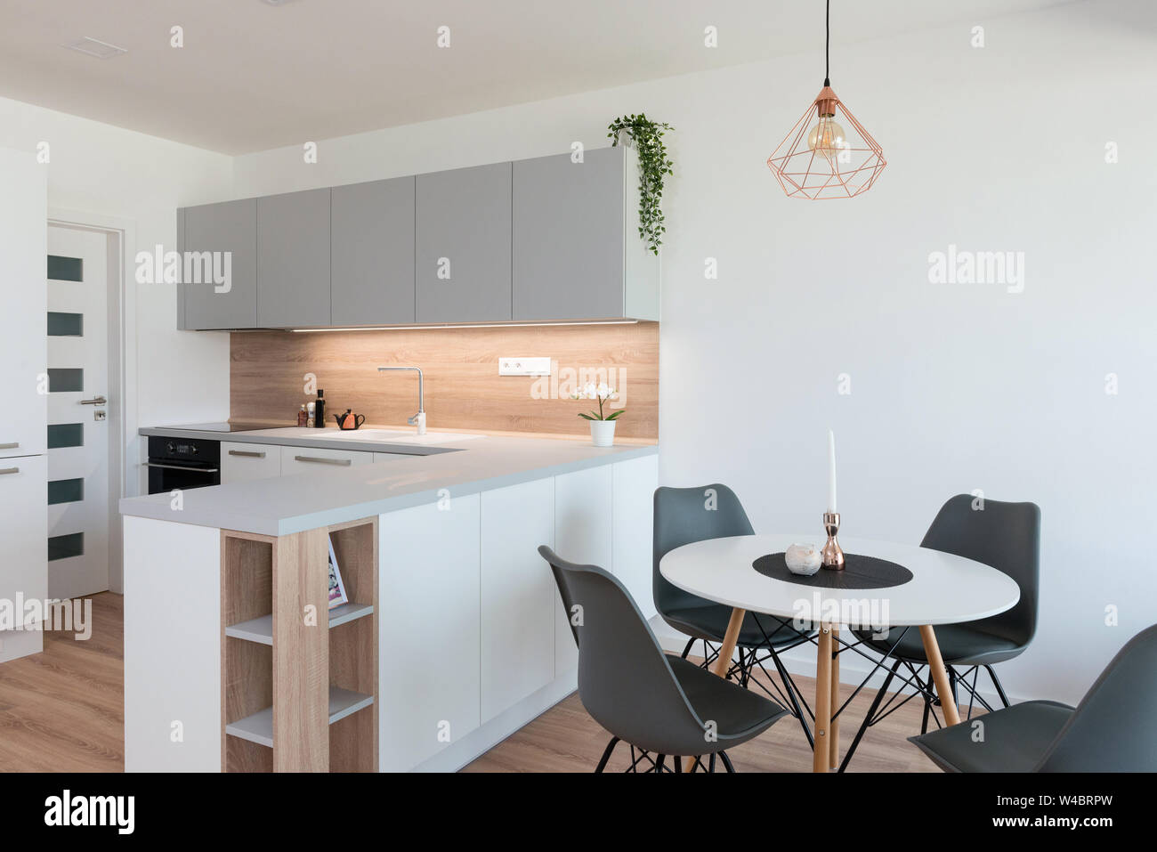 Interior of modern kitchen with dining table Stock Photo - Alamy