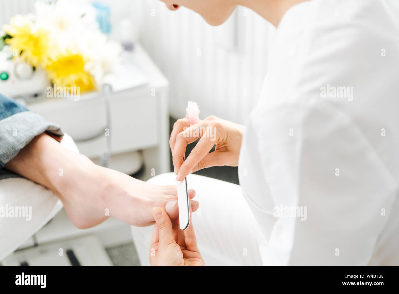 Podiatrist working on men's feet Stock Photo - Alamy