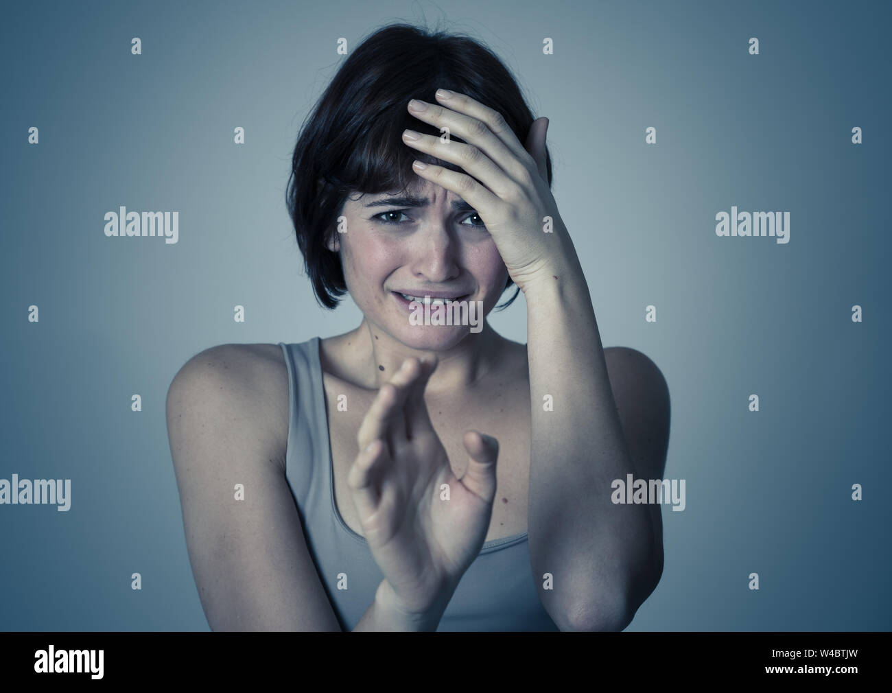 Portrait of young woman feeling scared and shocked making fear, anxiety ...