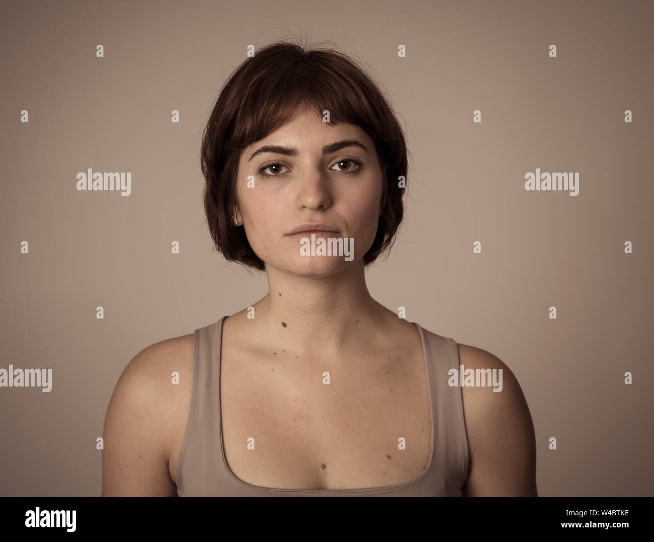 Close up of a young sad woman, serious and concerned, looking worried ...