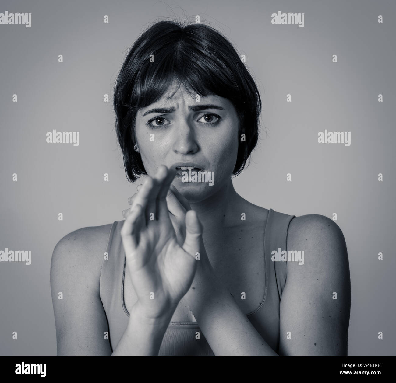 Black and white close up of young woman feeling scared and shocked ...