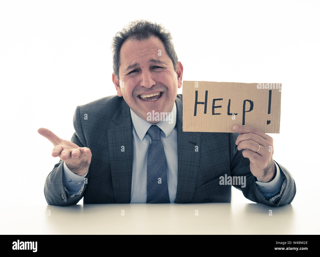 Stressed and desperate middle aged caucasian businessman holding a help ...