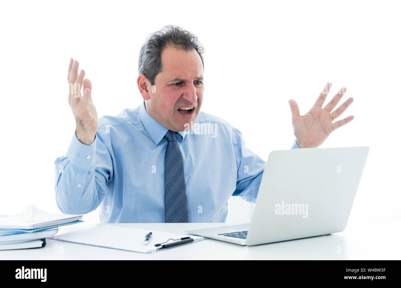 Angry and frustrated middle aged businessman overworked at desk upset ...