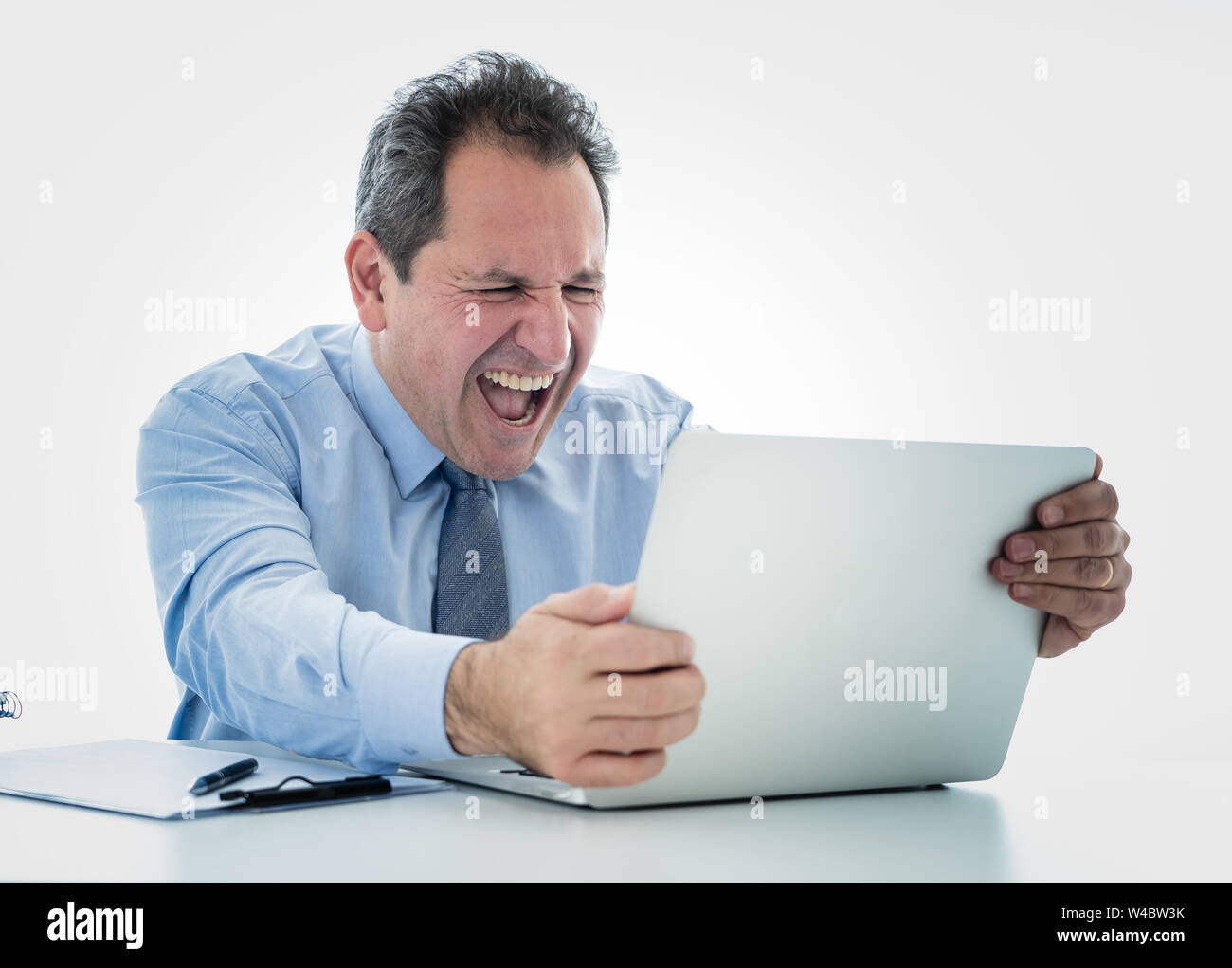 Angry and frustrated middle aged businessman overworked at desk upset ...