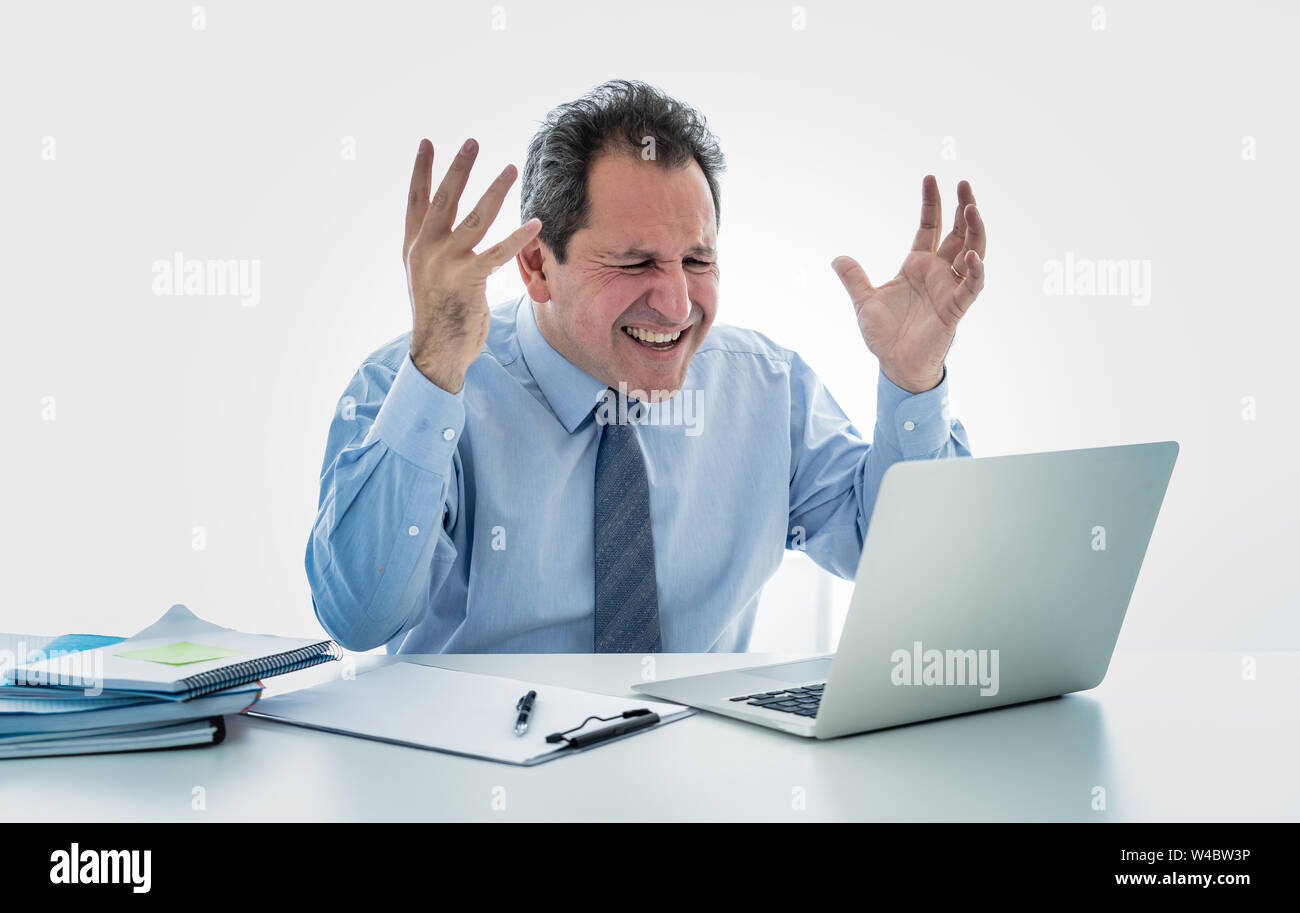 Angry and frustrated middle aged businessman overworked at desk upset ...