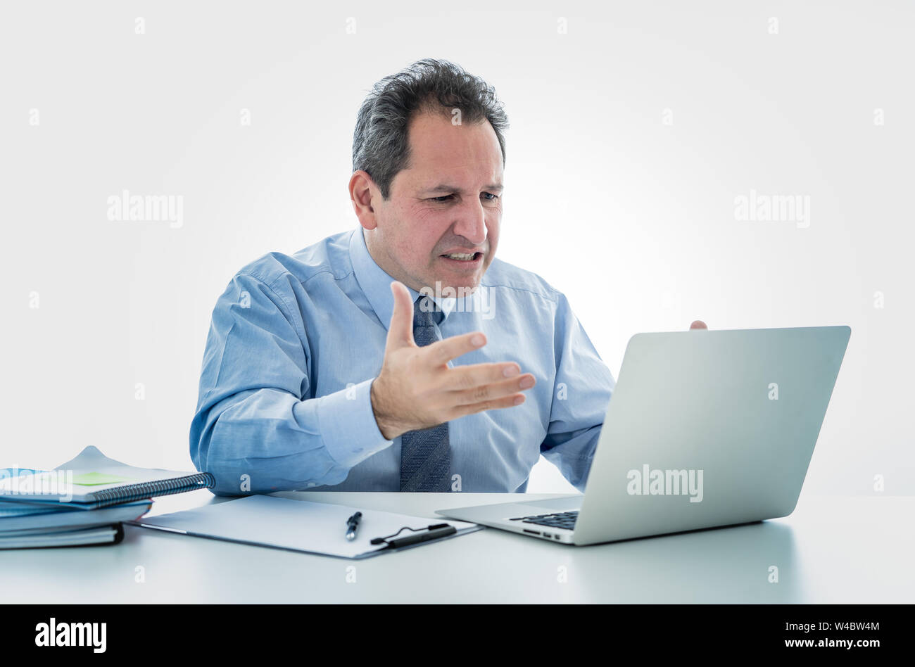 Angry and frustrated middle aged businessman overworked at desk upset ...