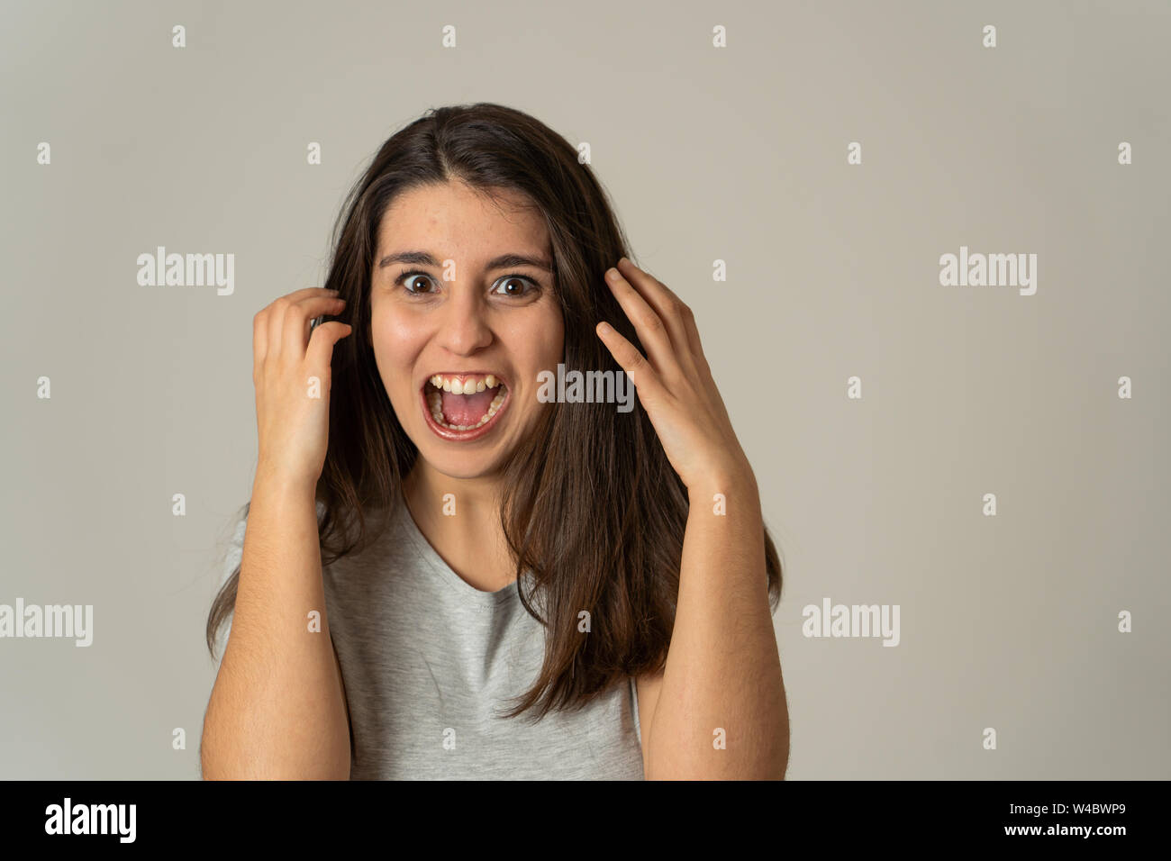 Portrait of beautiful shocked woman hearing good news, winning lottery ...
