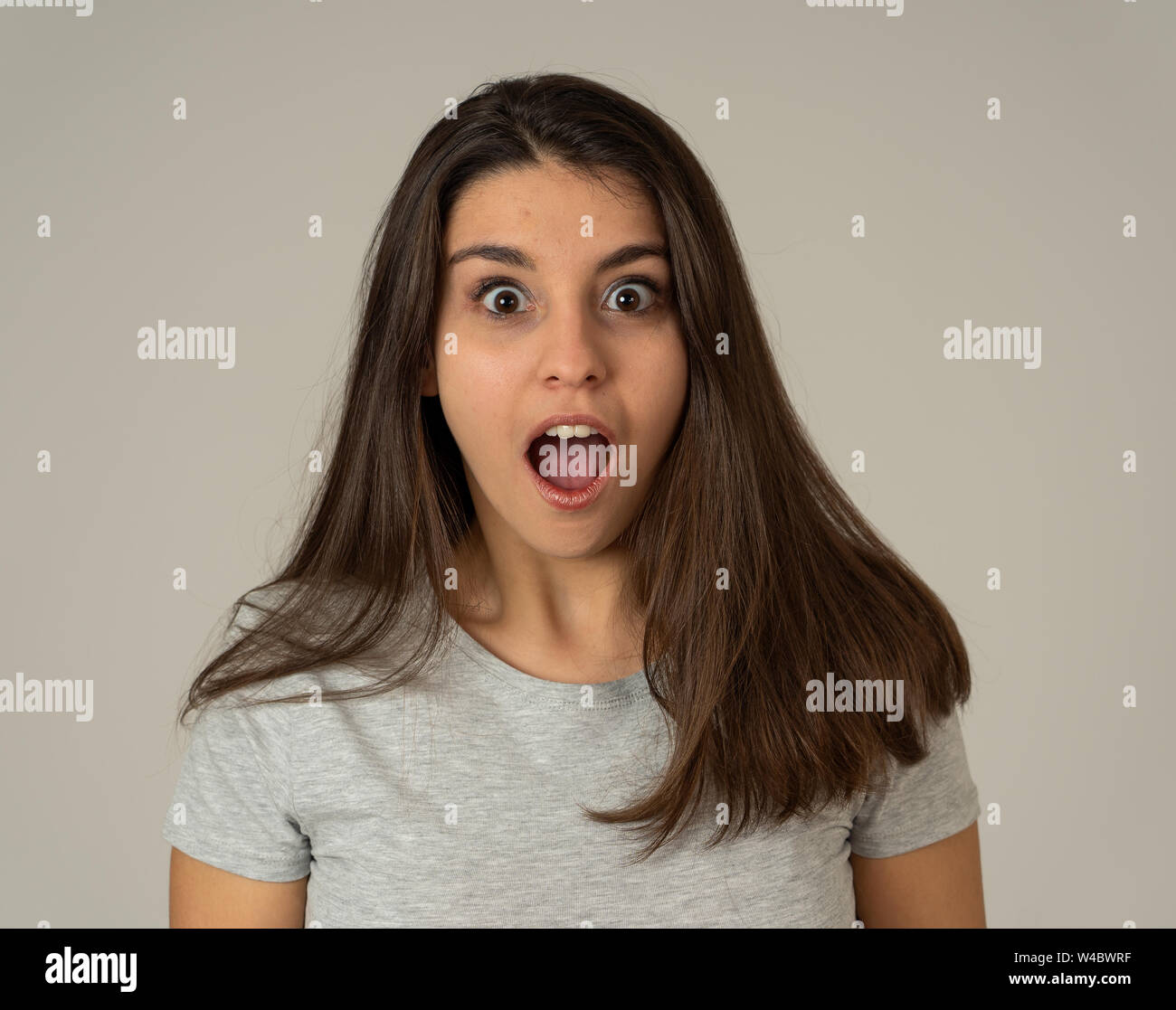 Portrait of beautiful shocked woman hearing good news, winning lottery ...