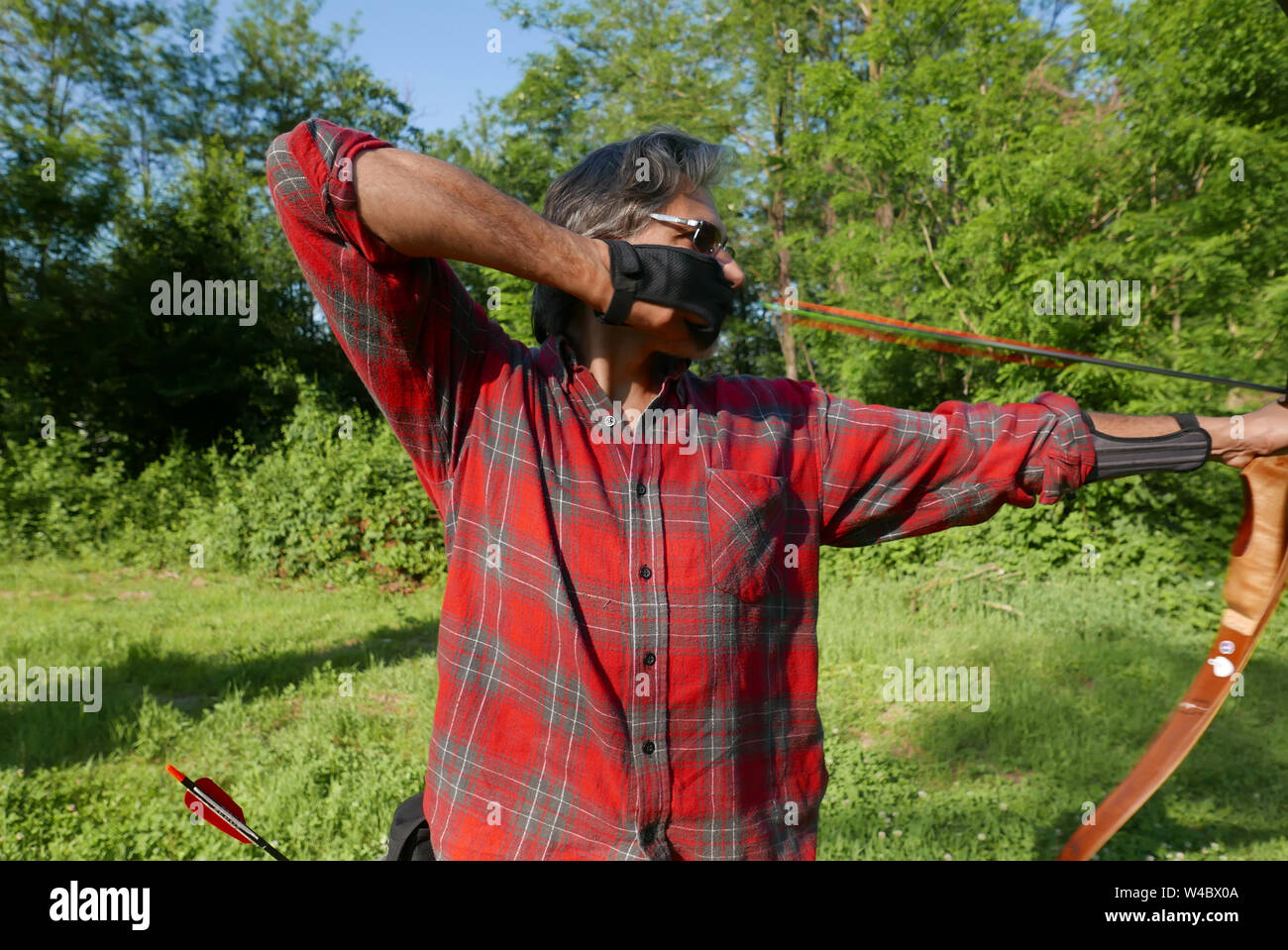 archer shooting arrow with motion blur Stock Photo - Alamy