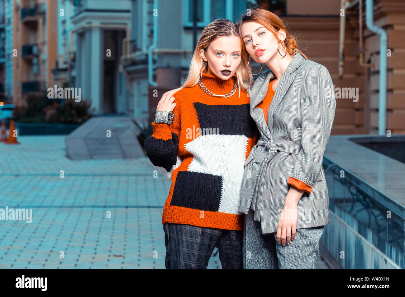 Two fashionable models feeling amazing while posing Stock Photo - Alamy