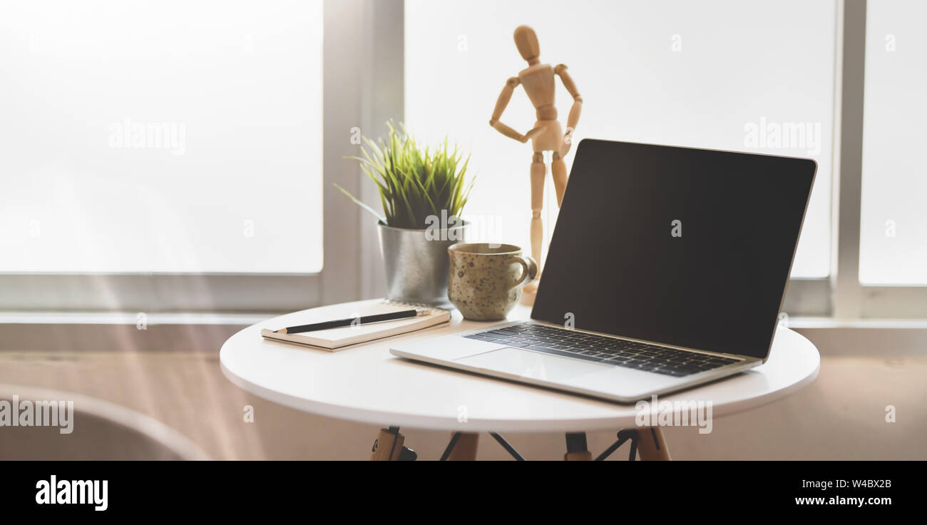 Open laptop computer on white wooden table in modern freelance ...