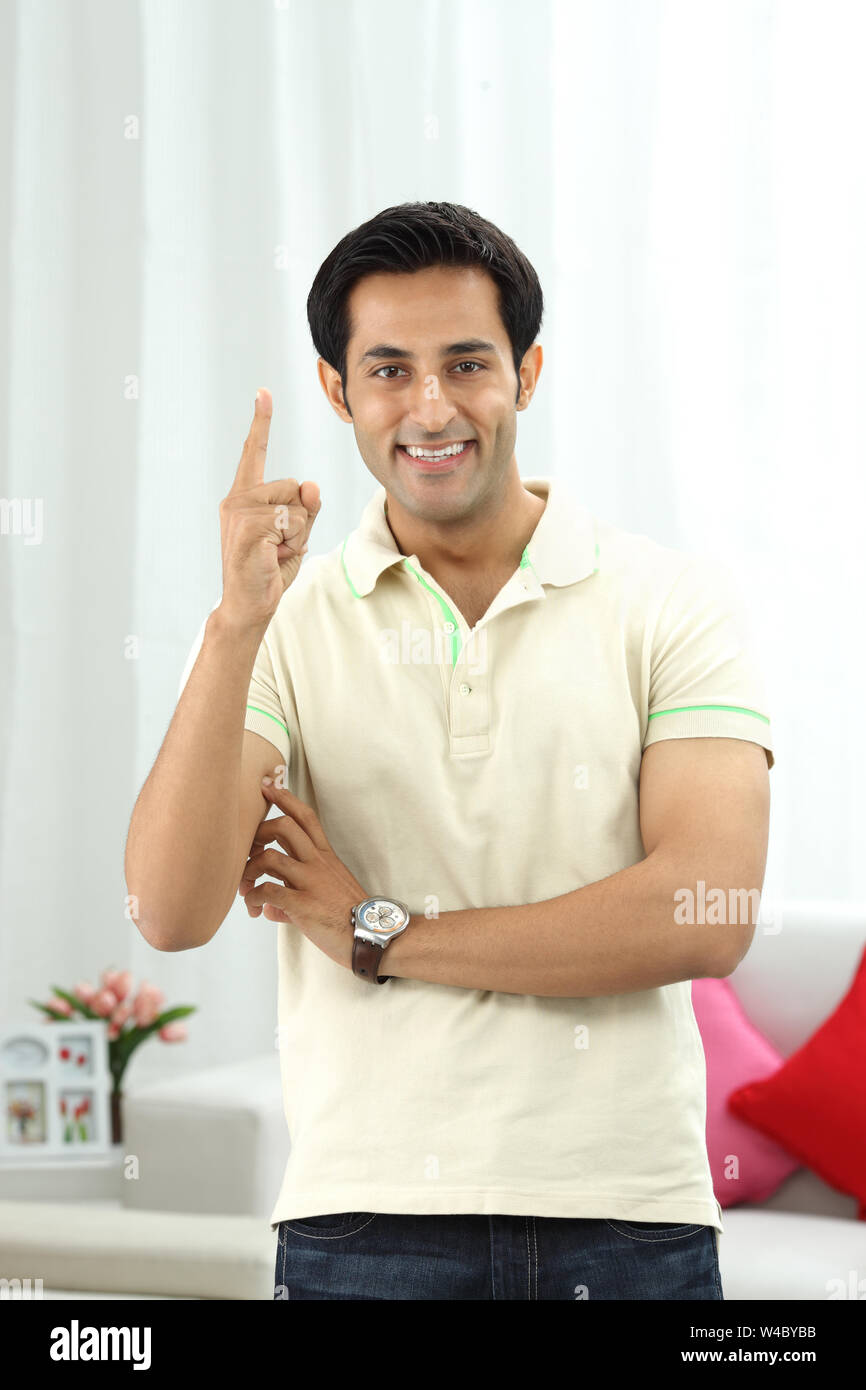 Portrait of a man pointing upward Stock Photo - Alamy